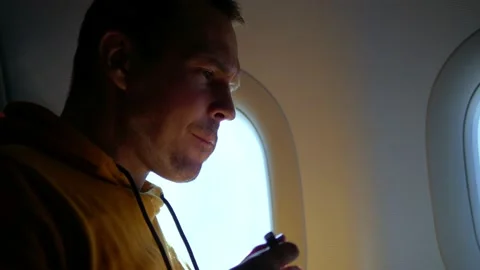 man eating airline food on the plane aga... | Stock Video | Pond5