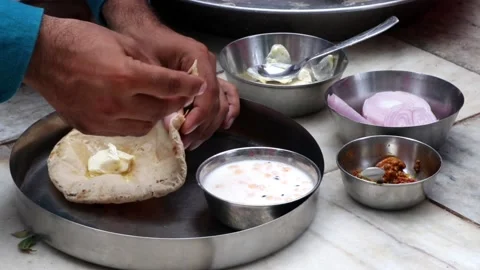 A man eating roti (chapati) with ghee (b... | Stock Video | Pond5