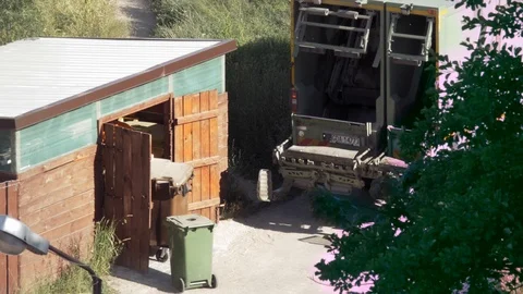 Man Empties Trash Cans Into A Garbage Tr... | Stock Video | Pond5