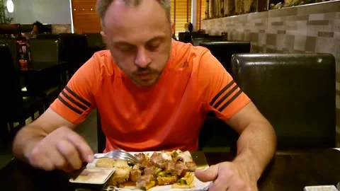 Man is enjoying eating beef hibachi at t... | Stock Video | Pond5