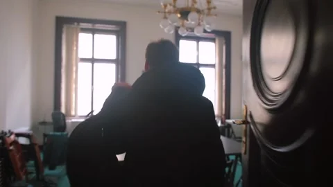 A man enters the apartment at the door. ... | Stock Video | Pond5