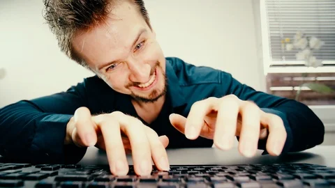 Man evil laugh while typing on keyboard ... | Stock Video | Pond5