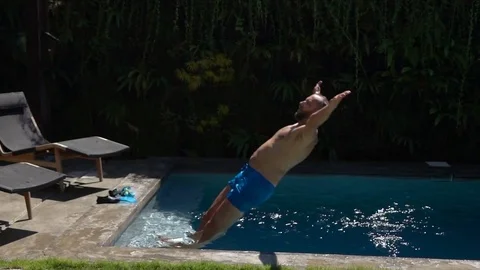 Man falling into the swimming pool, slow... | Stock Video | Pond5