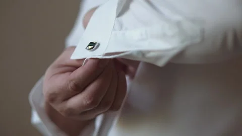 a man fastens a cufflink on his shirt | Stock Video | Pond5