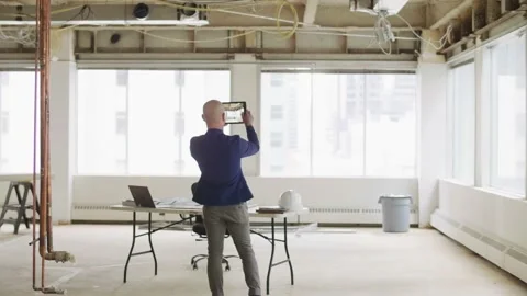 Man filming on tablet in empty office sp... | Stock Video | Pond5