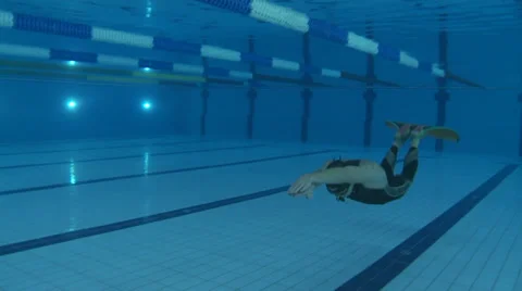 man fin swimming in swimming pool - unde... | Stock Video | Pond5