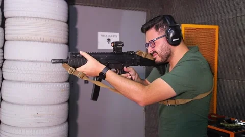 Man firing an assault rifle at an indoor... | Stock Video | Pond5