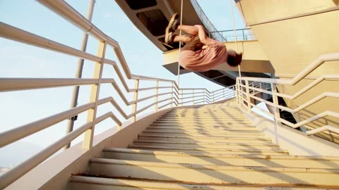 a man flips backwards on the stairs and ... | Stock Video | Pond5