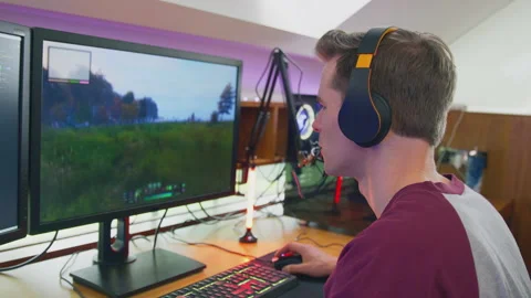 Man Gaming At Home Sitting At Desk Weari... | Stock Video | Pond5