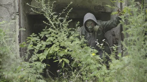 Man with gas mask comes out from shelter... | Stock Video | Pond5