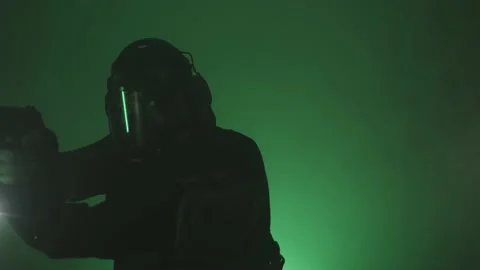 A man in a gas mask with a gun. Green ba... | Stock Video | Pond5