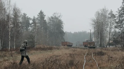 Man in gas mask walking on rail at deser... | Stock Video | Pond5