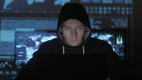 Man geek hacker in hood working at compu... | Stock Video | Pond5