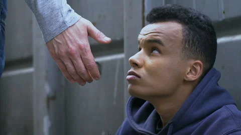 Man giving helping hand to homeless guy,... | Stock Video | Pond5