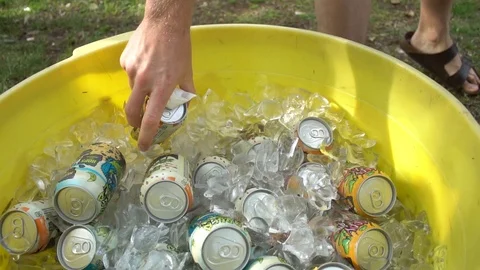 Man grabbing a cool drink from an ice bu... | Stock Video | Pond5