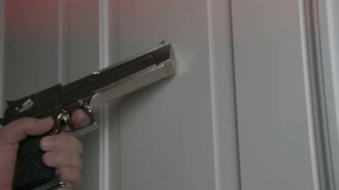 Man with a gun, knocking on a door at ni... | Stock Video | Pond5