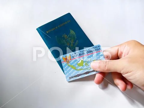 Man hand holding Indonesian citizen identity card with white background ...