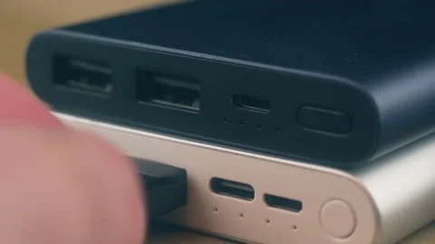 Man hand insert 4 USB cables to power ba... | Stock Video | Pond5