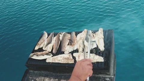 Man hand turning fish on barbecue, manga... | Stock Video | Pond5