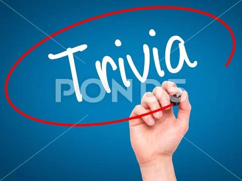 Photograph: Man Hand writing Trivia with black marker on visual screen ...