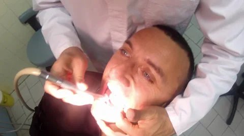 man having his teeth fixed at the dentis... | Stock Video | Pond5