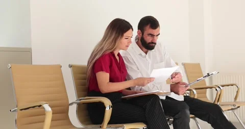 Man helps woman fill out form submitting... | Stock Video | Pond5