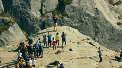 Man in hero pose on Pulpit rock, zoom pu... | Stock Video | Pond5