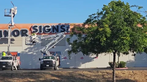 Man on hoist installing signage, new bus... | Stock Video | Pond5