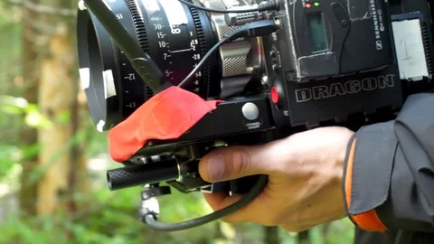 Man holding a camera filming a movie in ... | Stock Video | Pond5
