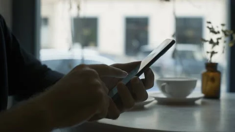 man holding cellphone, swiping photos in... | Stock Video | Pond5
