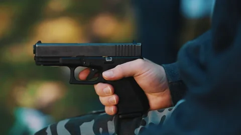 Man holding a gun in his hand. Glock saf... | Stock Video | Pond5