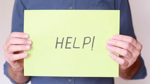 Man holding "Help" sign | Stock Video | Pond5