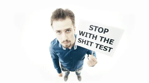 Man holding sign Stop With The Shit Test... | Stock Video | Pond5
