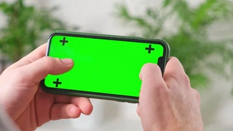 A man holds a phone with a green screen ... | Stock Video | Pond5