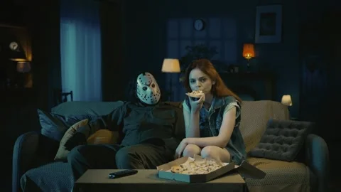 Man horror maniac sitting on the sofa wa... | Stock Video | Pond5