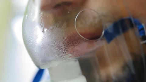 Man inhaling through inhaler mask.Inhale... | Stock Video | Pond5