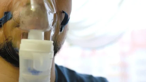 Man inhaling through inhaler mask.Inhale... | Stock Video | Pond5