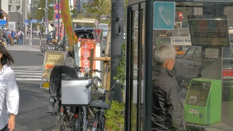 A man inside the telephone booth in Toky... | Stock Video | Pond5