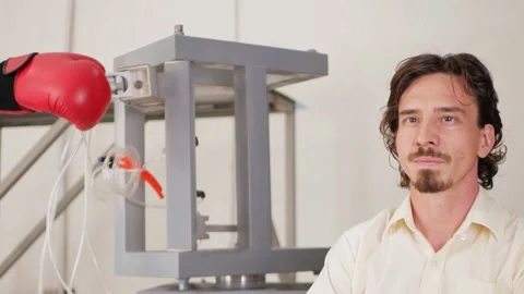 man inventor with his robot boxer, simul... | Stock Video | Pond5