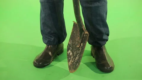 a man in jeans and boots stands with a s... | Stock Video | Pond5
