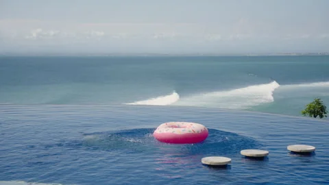 Man jump in inflatable ring ocean view i... | Stock Video | Pond5