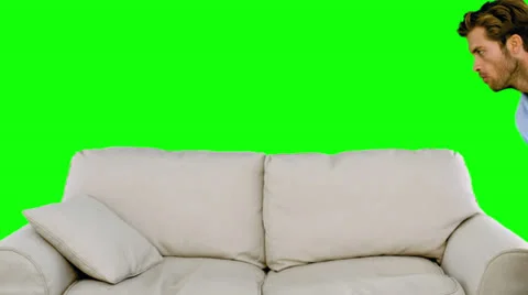 Man jumping on the sofa on green screen | Stock Video | Pond5