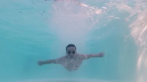 Man Jumping Into The Swimming Pool Under... | Stock Video | Pond5