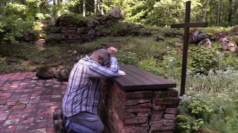 Man kneeling at the altar in outdoor chu... | Stock Video | Pond5