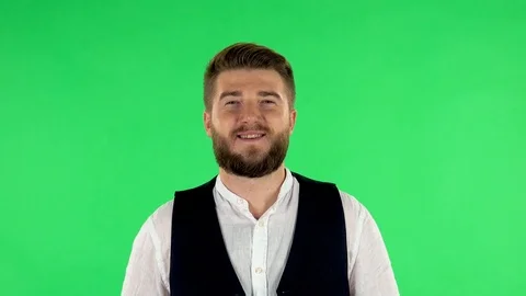 Man laughs while looking at camera. Gree... | Stock Video | Pond5