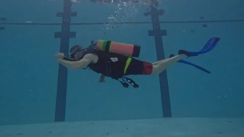 Man learning to scuba dive in pool adjus... | Stock Video | Pond5