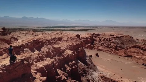 Man Lifting backpack in panoramic cliff | Stock Video | Pond5