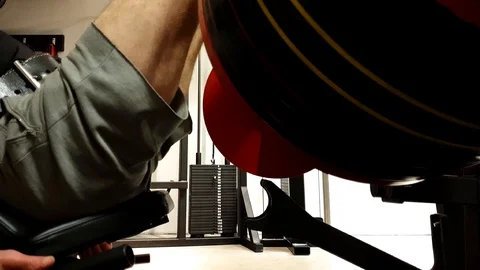 Man lifting heavy weights in leg press m... | Stock Video | Pond5