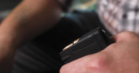 Man loading AR 15 bullets in to a magazi... | Stock Video | Pond5