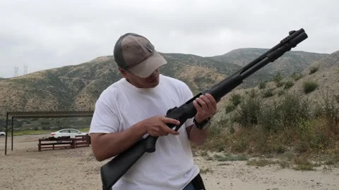 Man loading pump action shotgun | Stock Video | Pond5